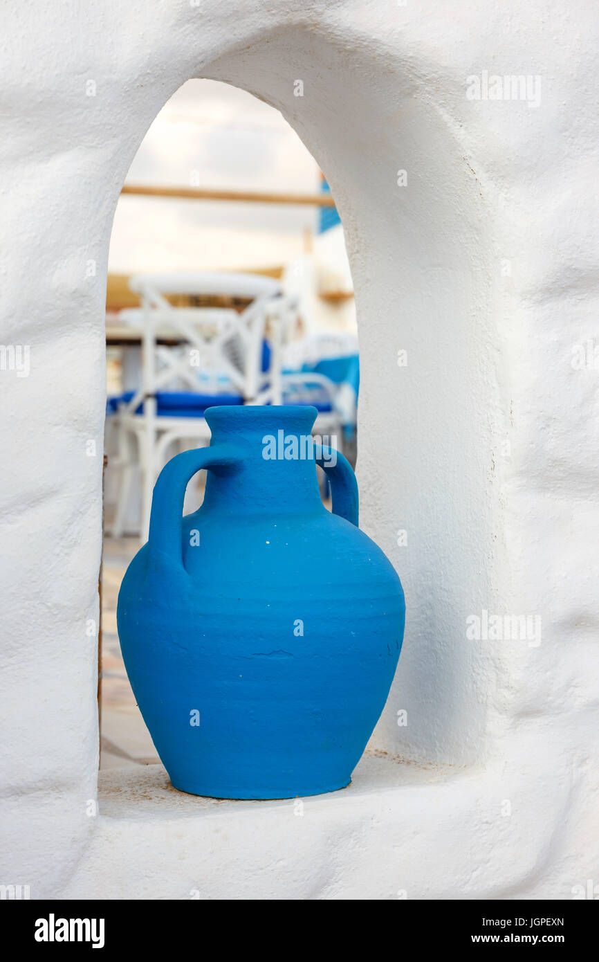 Greek style ceramic blue vase on white wall background Stock Photo - Alamy