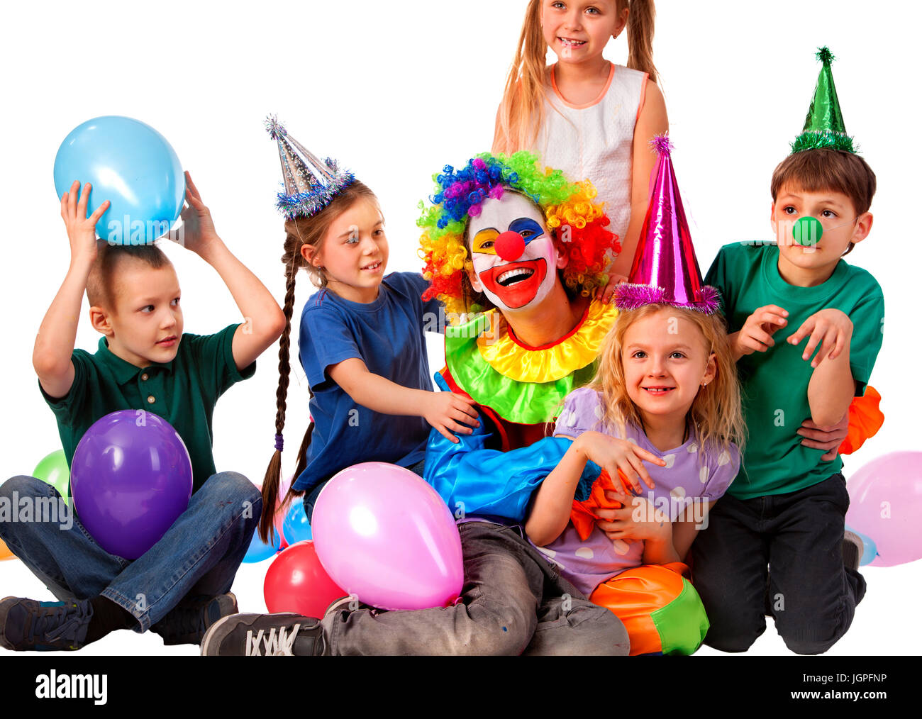 Birthday clown playing children. Kid wearing party hat hold balloons ...