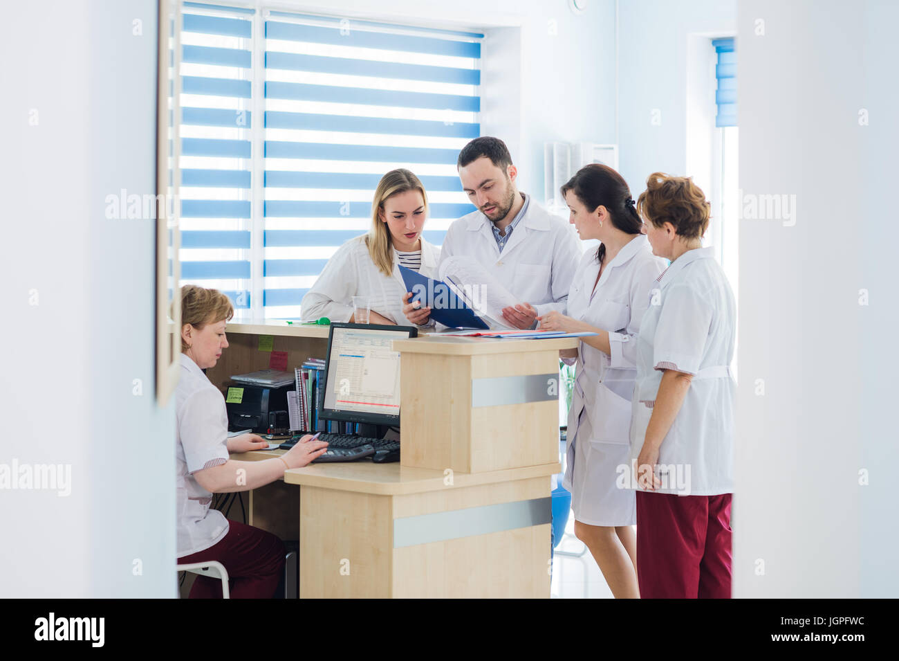 Doctor and receptionist at reception in a hospital Stock Photo - Alamy