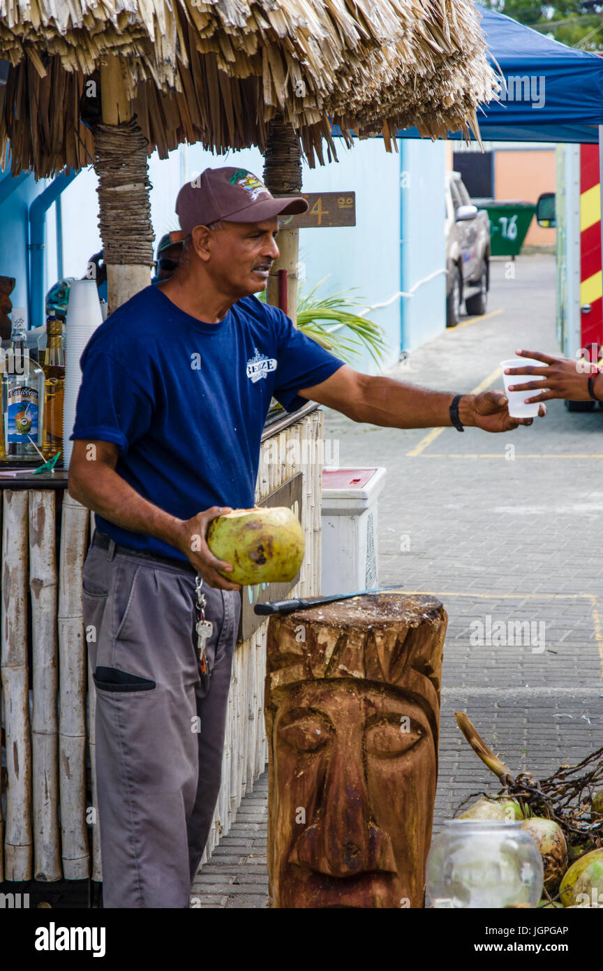 Man chopping coconuts into rum drinks at the Coconut Bar in Belize City ...
