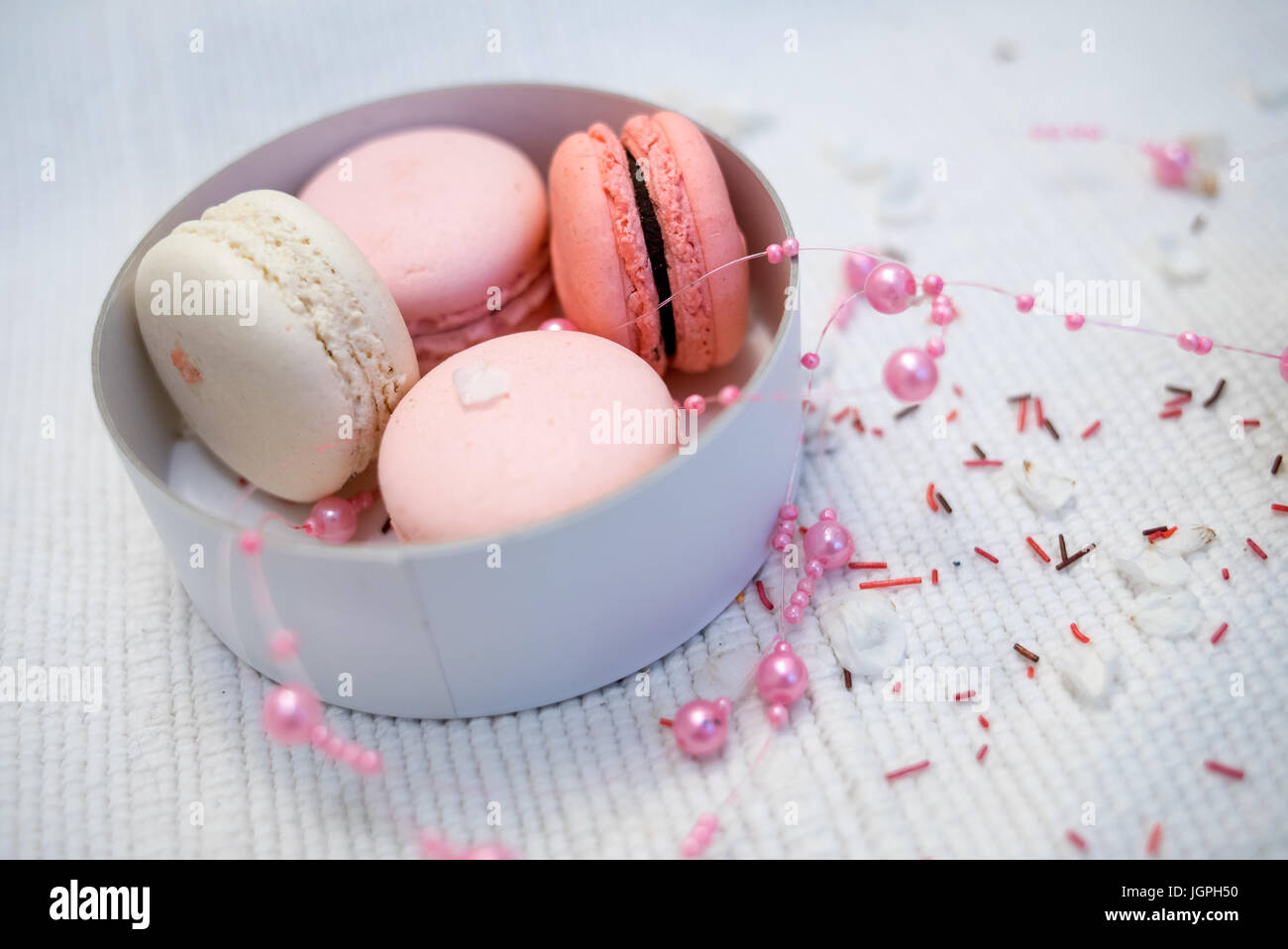 Pastel pink and rose macaroons in a white deep paper bowl Stock Photo ...