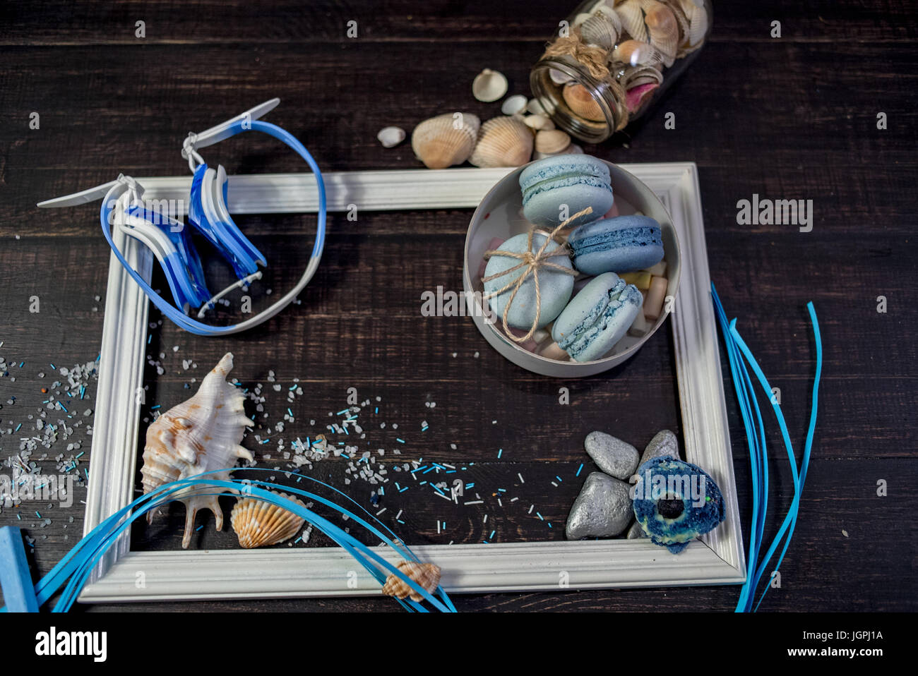 Blue and sea blue macaroons in a marine theme on a dark background ...