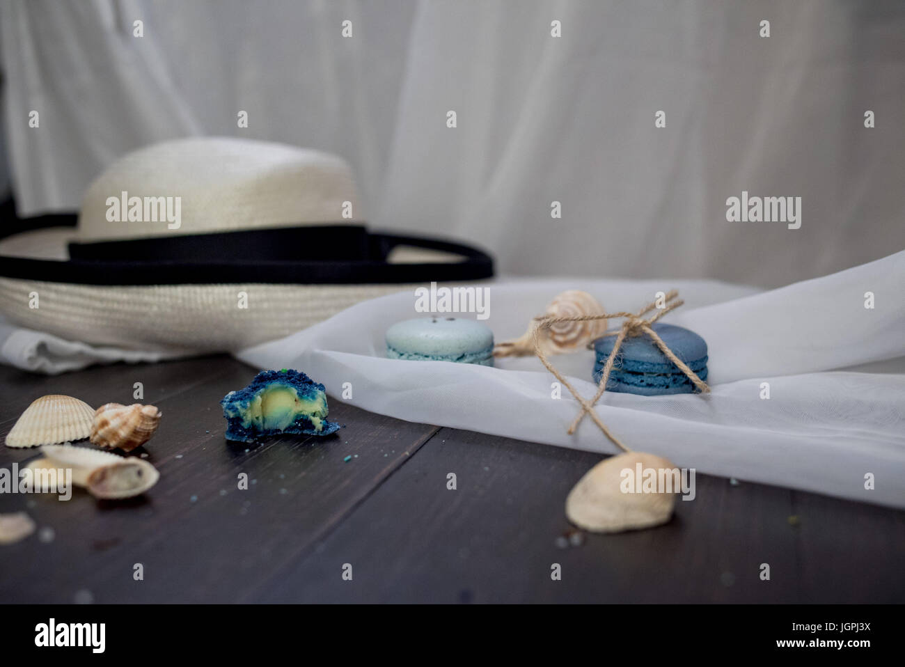 Blue and sea blue macaroons in a marine theme on a dark background ...