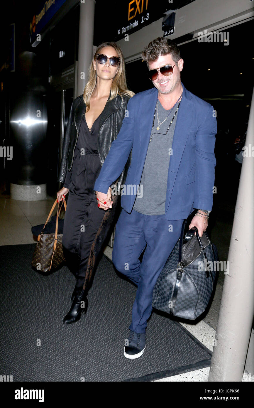 Robin Thicke and April Love Geary arriving at Los Angeles International ...