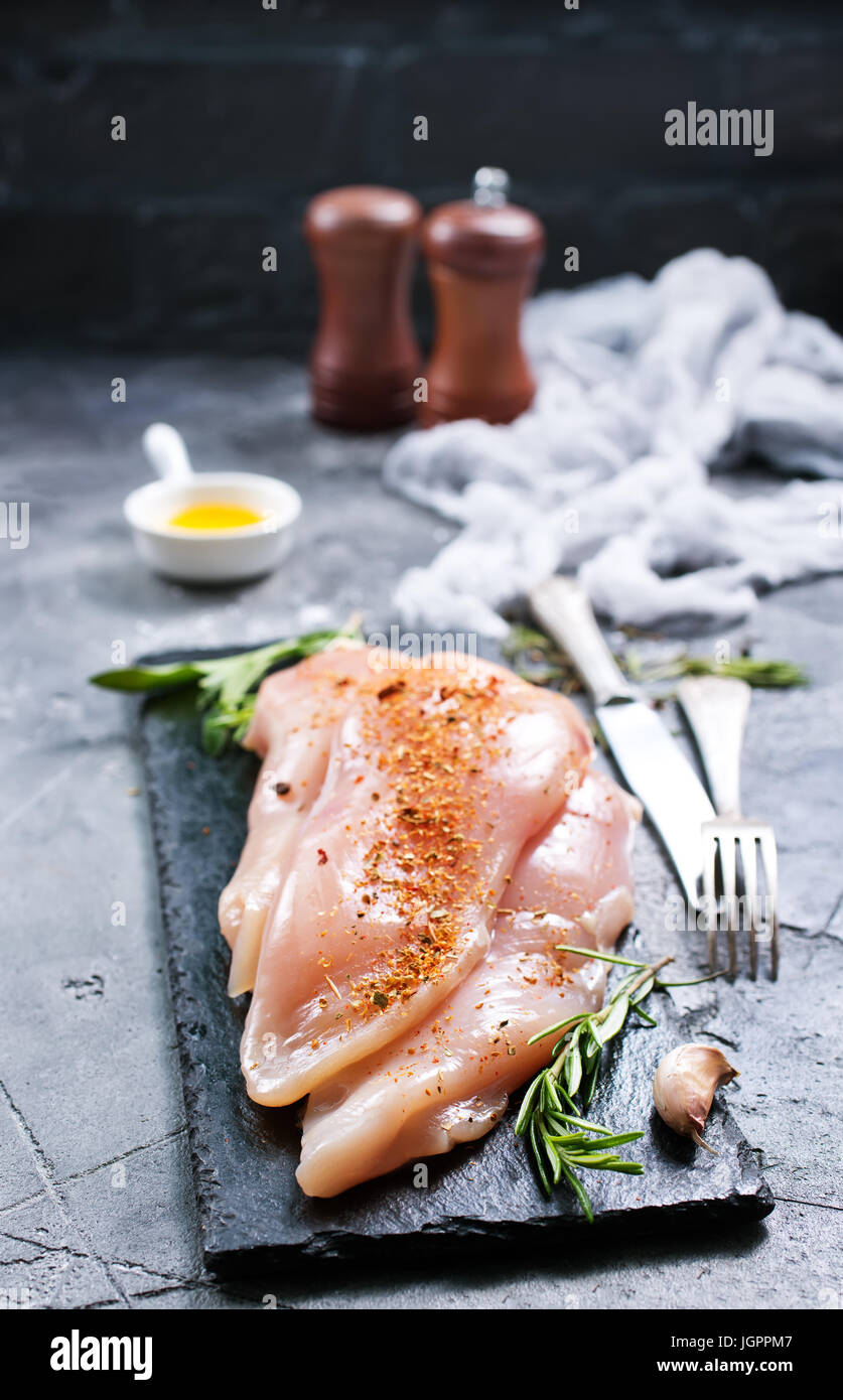 raw chicken fillet with spice on a table Stock Photo - Alamy