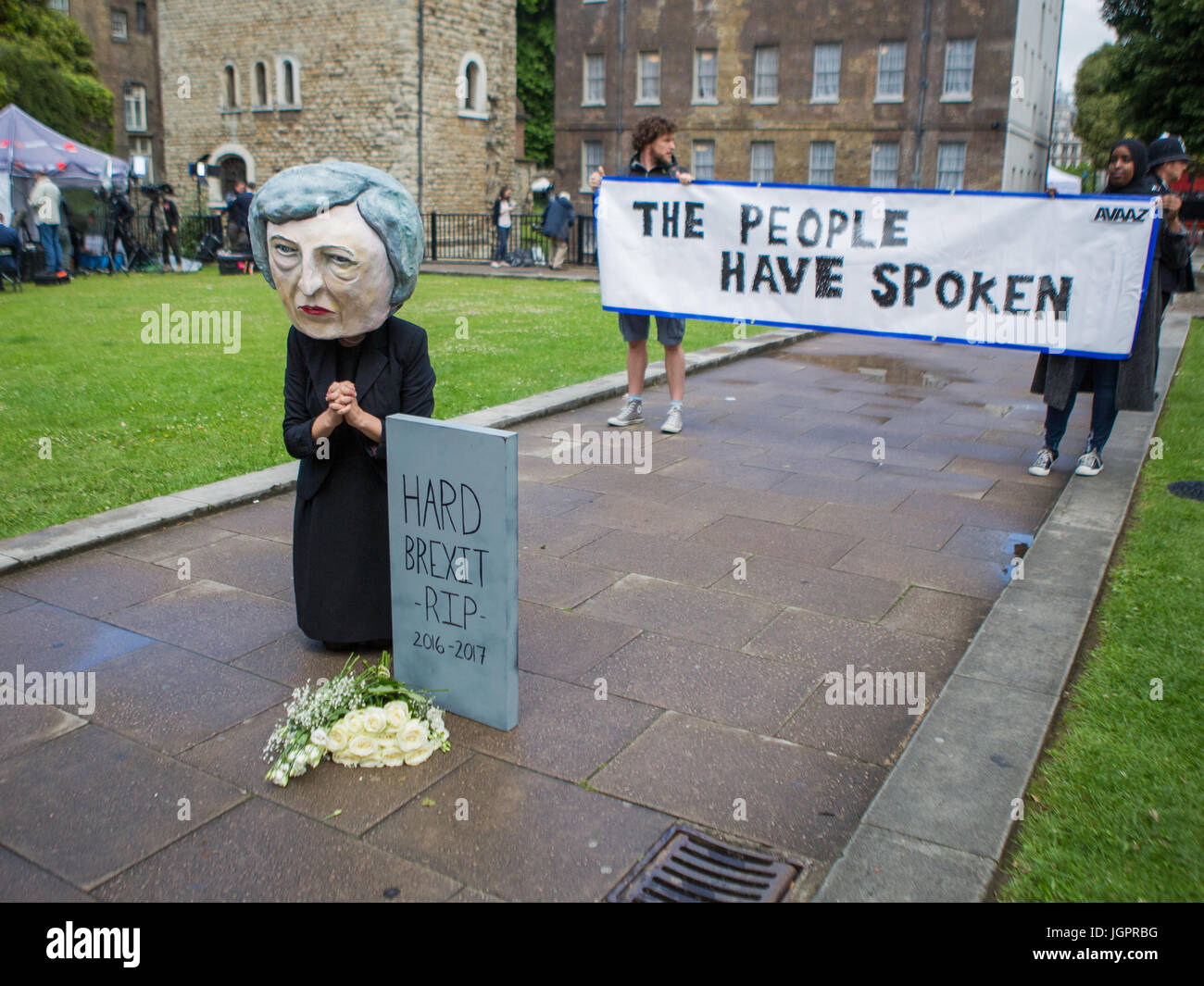 Theresa May big head kneeling next to 'hard brexit RIP' gravestone on ...