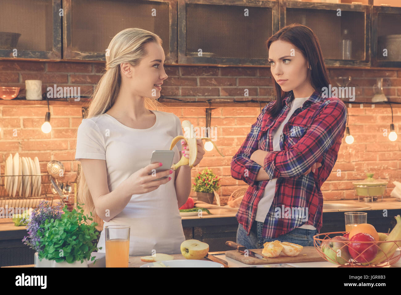 Young women friends cooking meal together at home Stock Photo - Alamy
