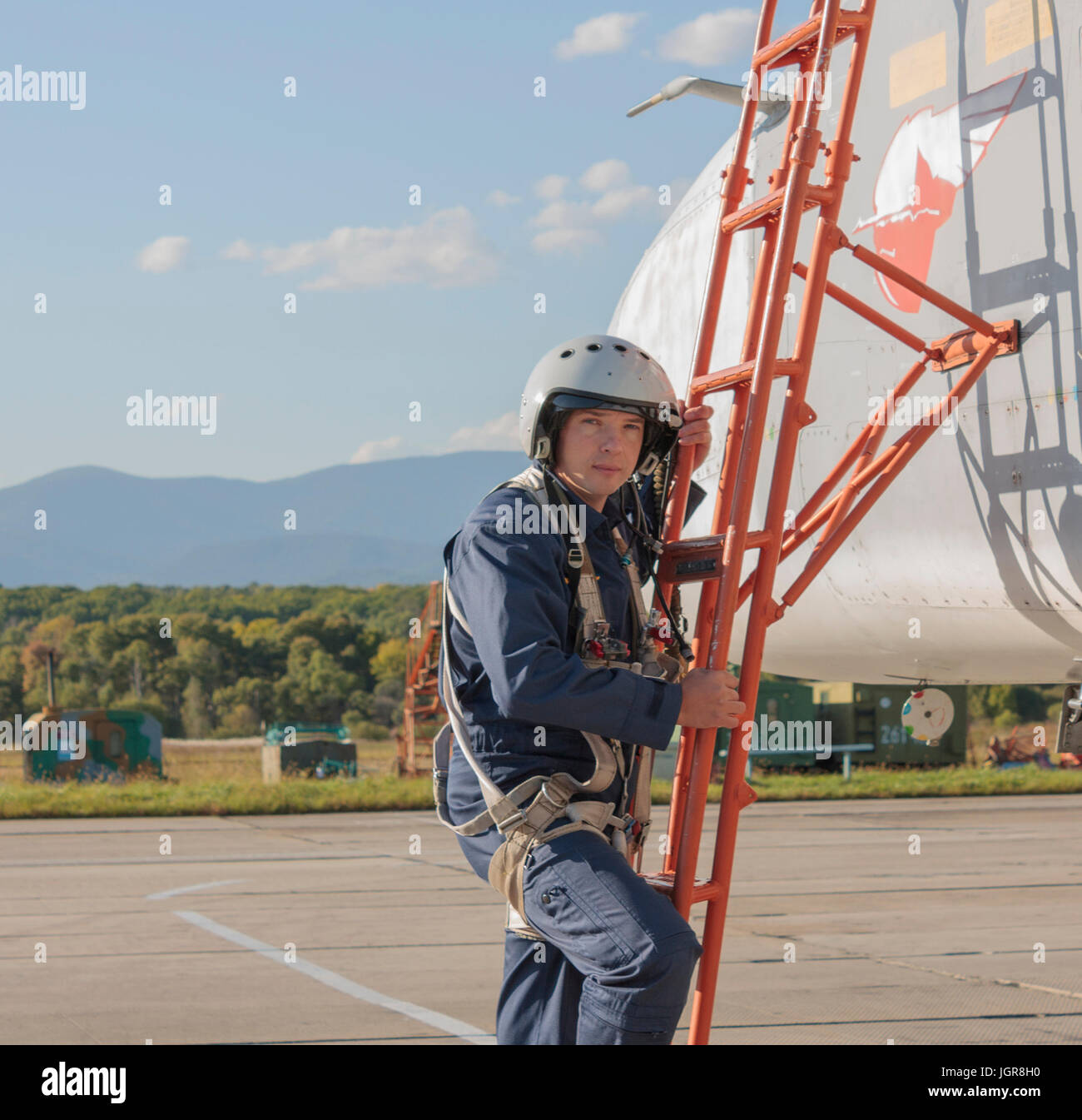 Military pilot in helmet stands near jet plane Stock Photo - Alamy