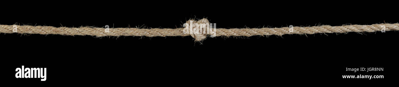 Long rope tied in a knot Stock Photo - Alamy