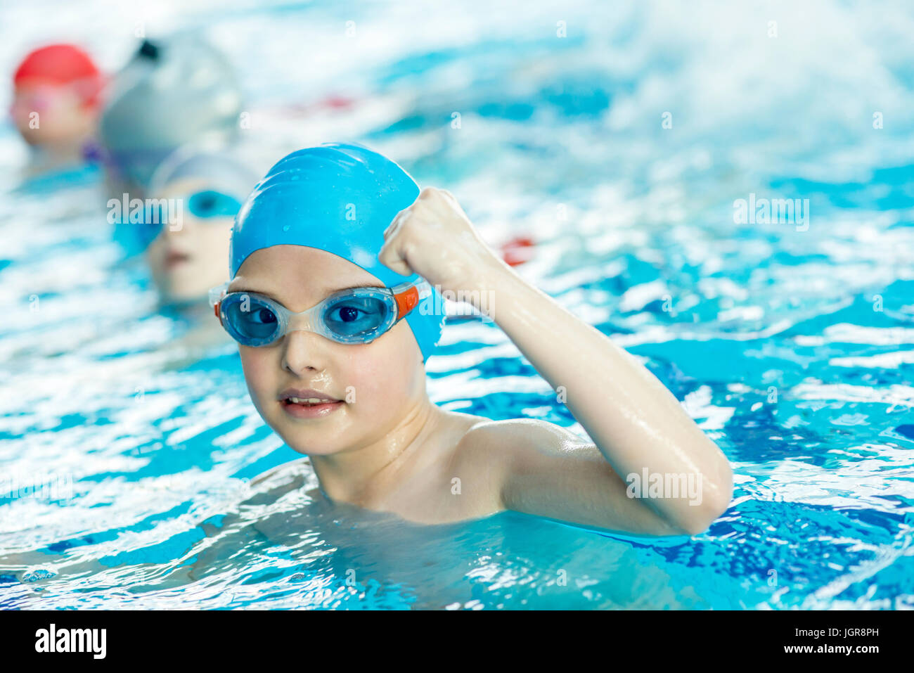 happy children kids group at swimming pool class learning to swim Stock ...