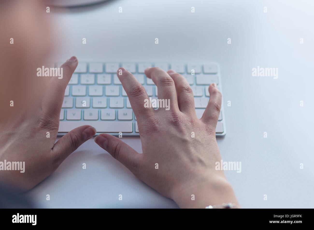 Female office worker typing on the keyboard Stock Photo - Alamy