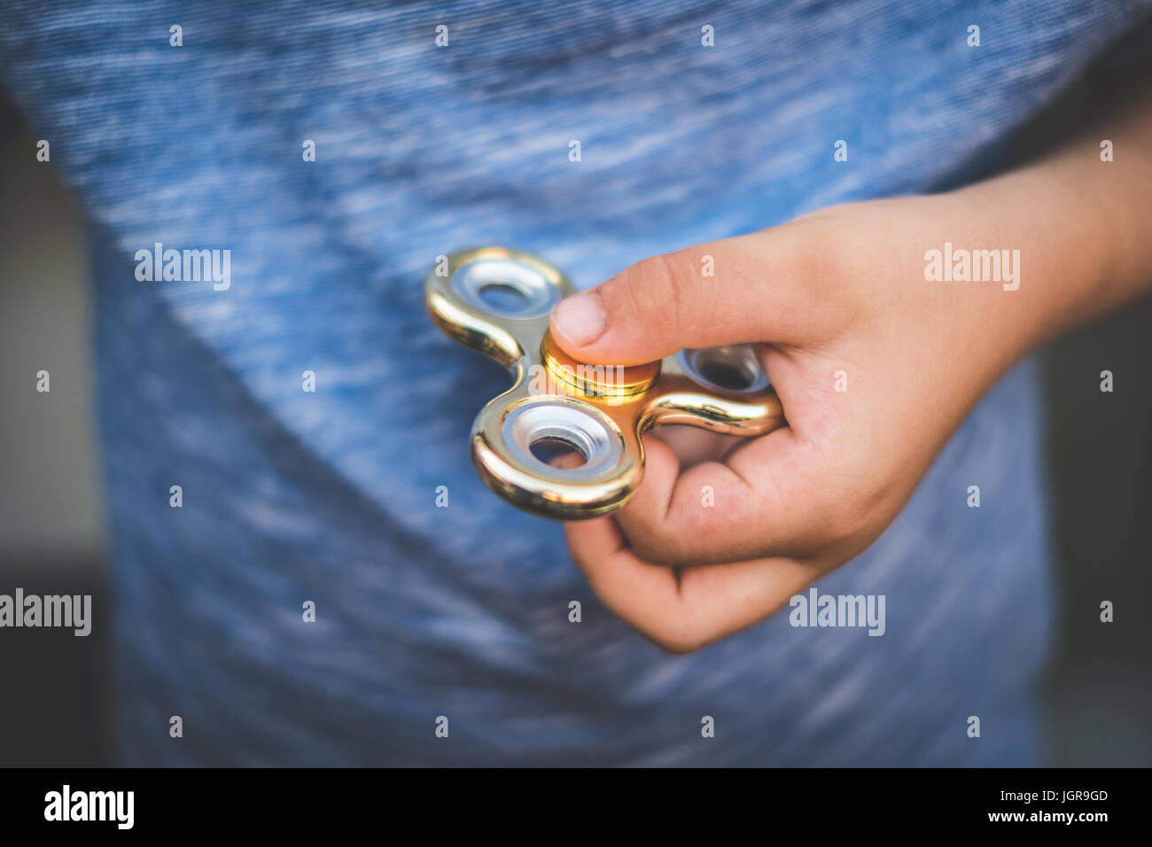 fidget, finger spinner - child holding fidget, finger spinner Stock ...