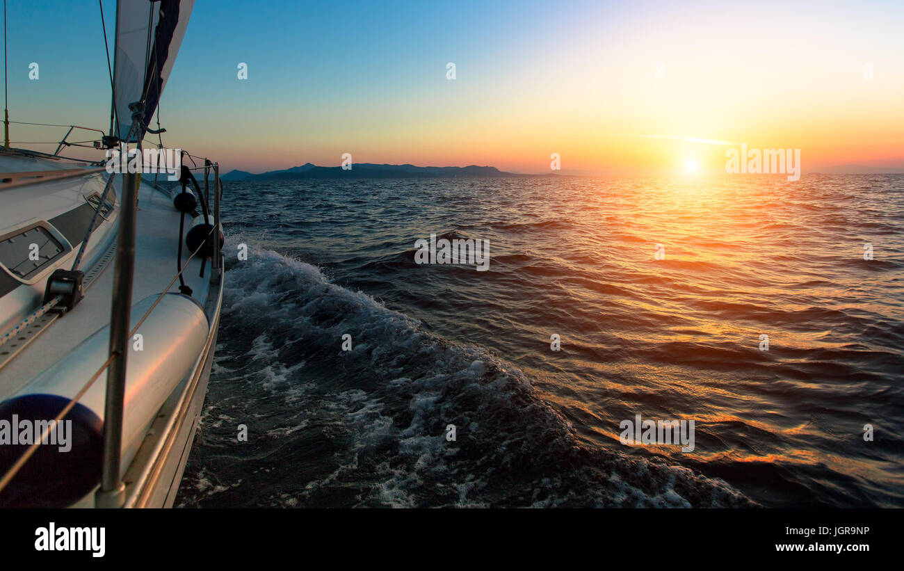 Sunset from the deck of the sailing boat moving in a sea Stock Photo ...