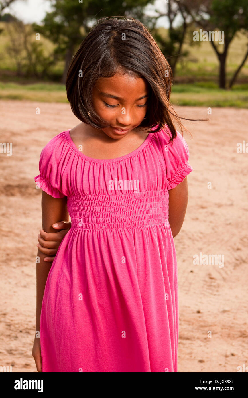 Happy Hispanic little girl playing outside on a farm Stock Photo - Alamy