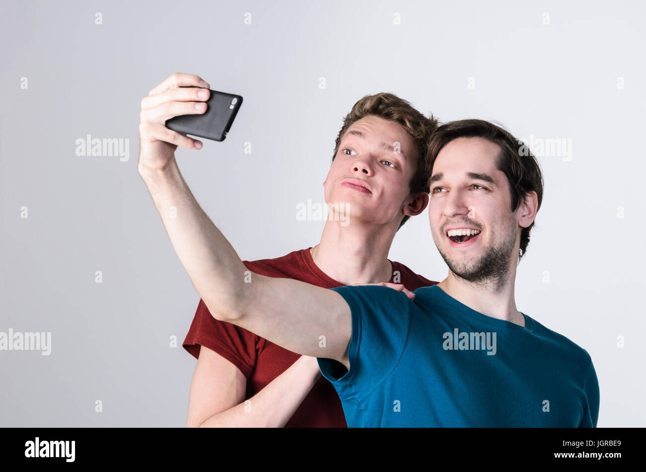 Two happy friends taking selfie on mobile phone camera Stock Photo - Alamy
