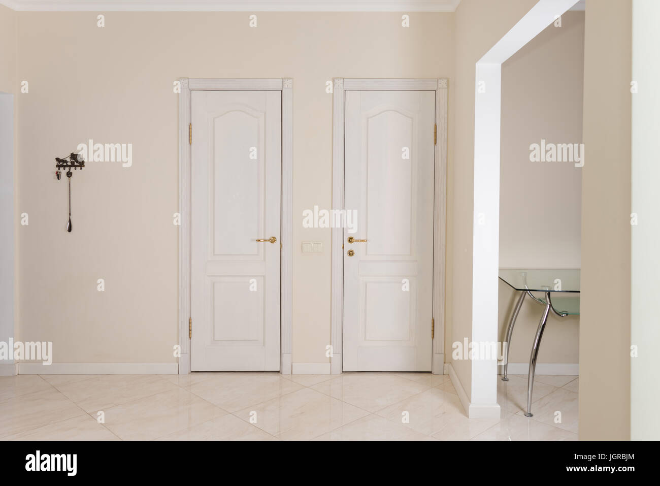 House interior. Entrance hallway with white doors to walk-in closet and ...