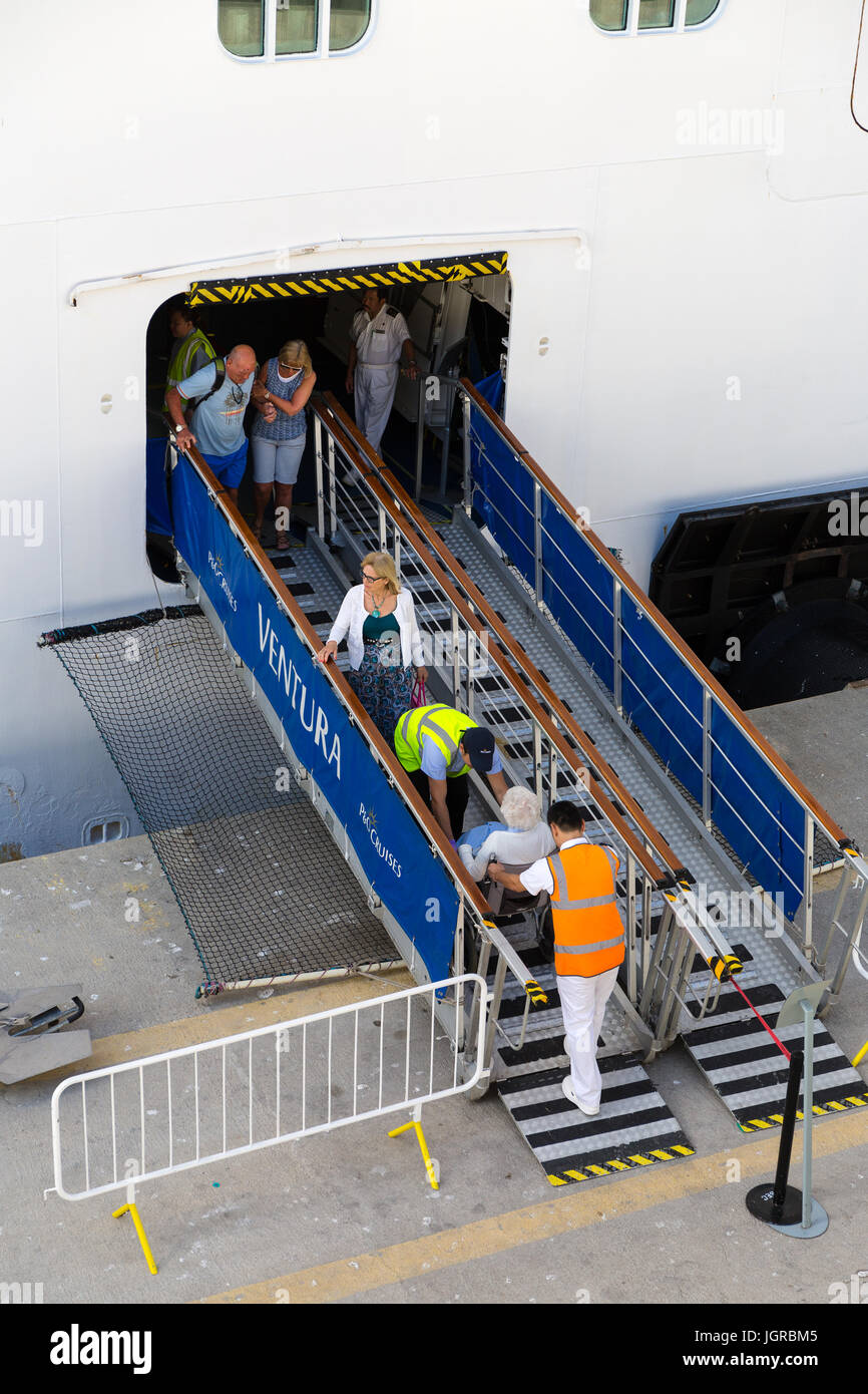 Elderly passengers leaving down ramp from Cruise ship, with assistance ...