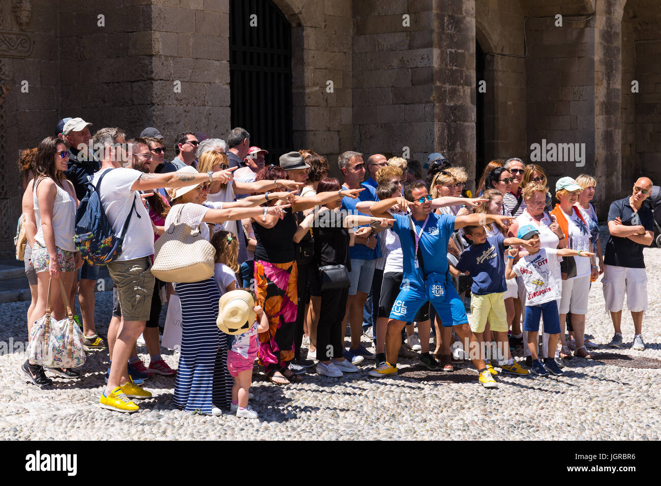 Group of Tourists being photographed and posing for summer vacation fun ...