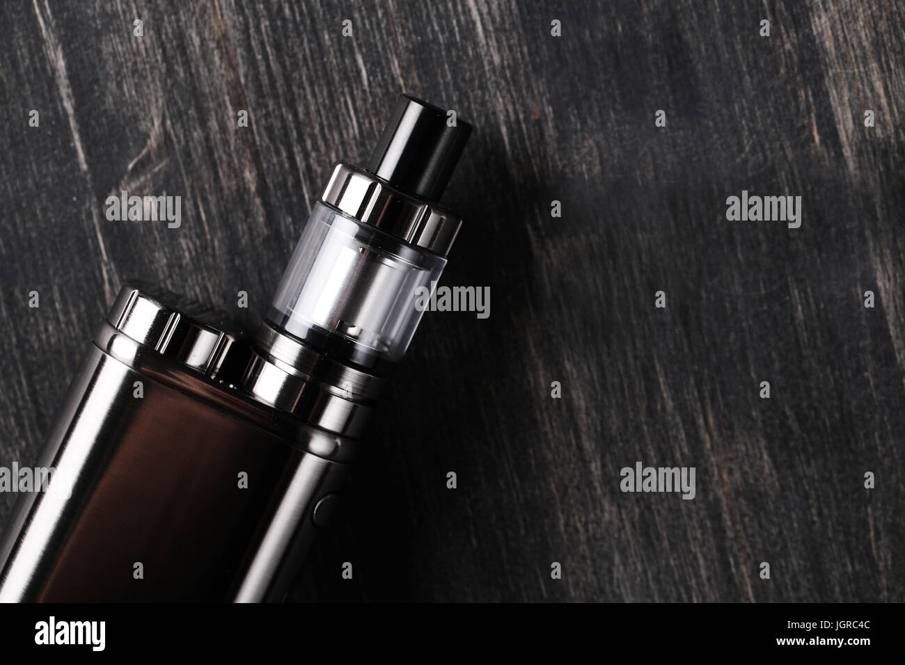 Vaping device on the wooden table Stock Photo - Alamy