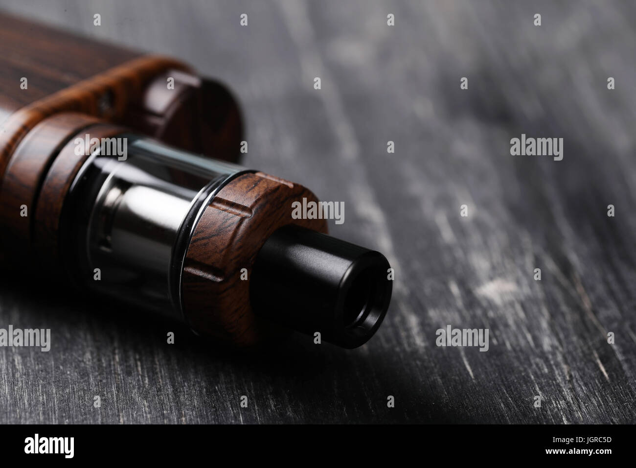 Vaping device on the wooden table Stock Photo - Alamy