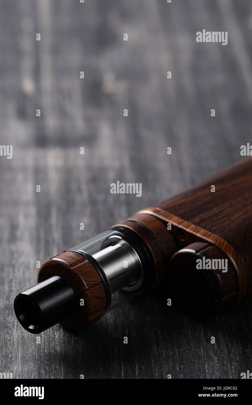 Vaping device on the wooden table Stock Photo - Alamy