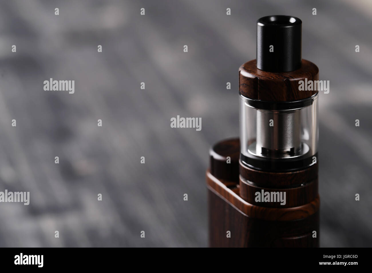 Vaping device on the wooden table Stock Photo - Alamy