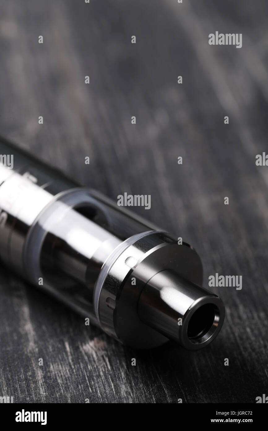 Vaping device on the wooden table Stock Photo - Alamy