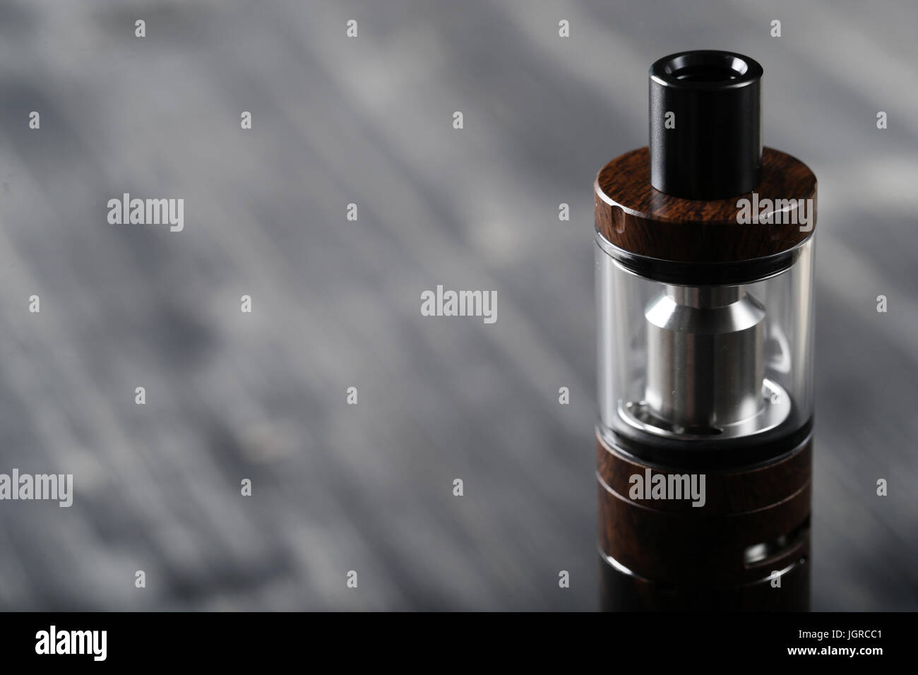 Vaping device on the wooden table Stock Photo - Alamy