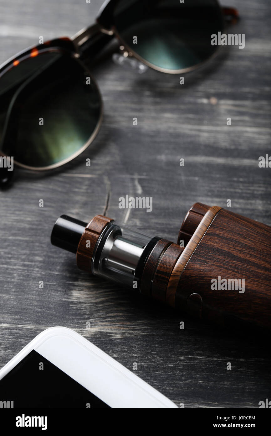 Vaping device on the wooden table Stock Photo - Alamy