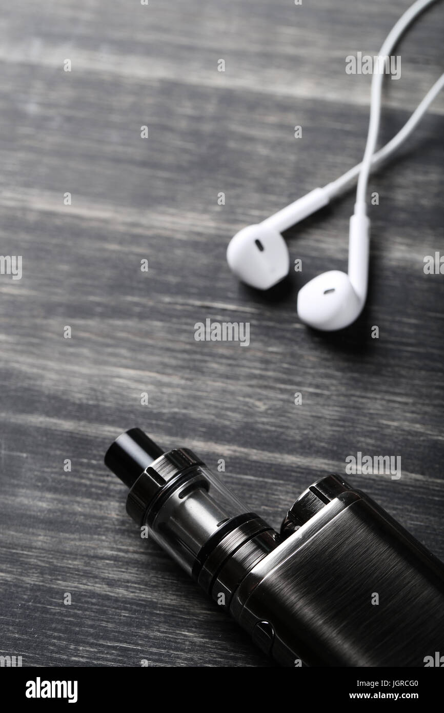 Vaping device on the wooden table Stock Photo - Alamy
