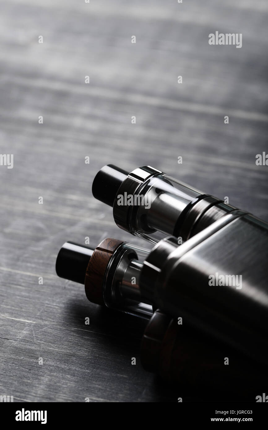 Vaping device on the wooden table Stock Photo - Alamy