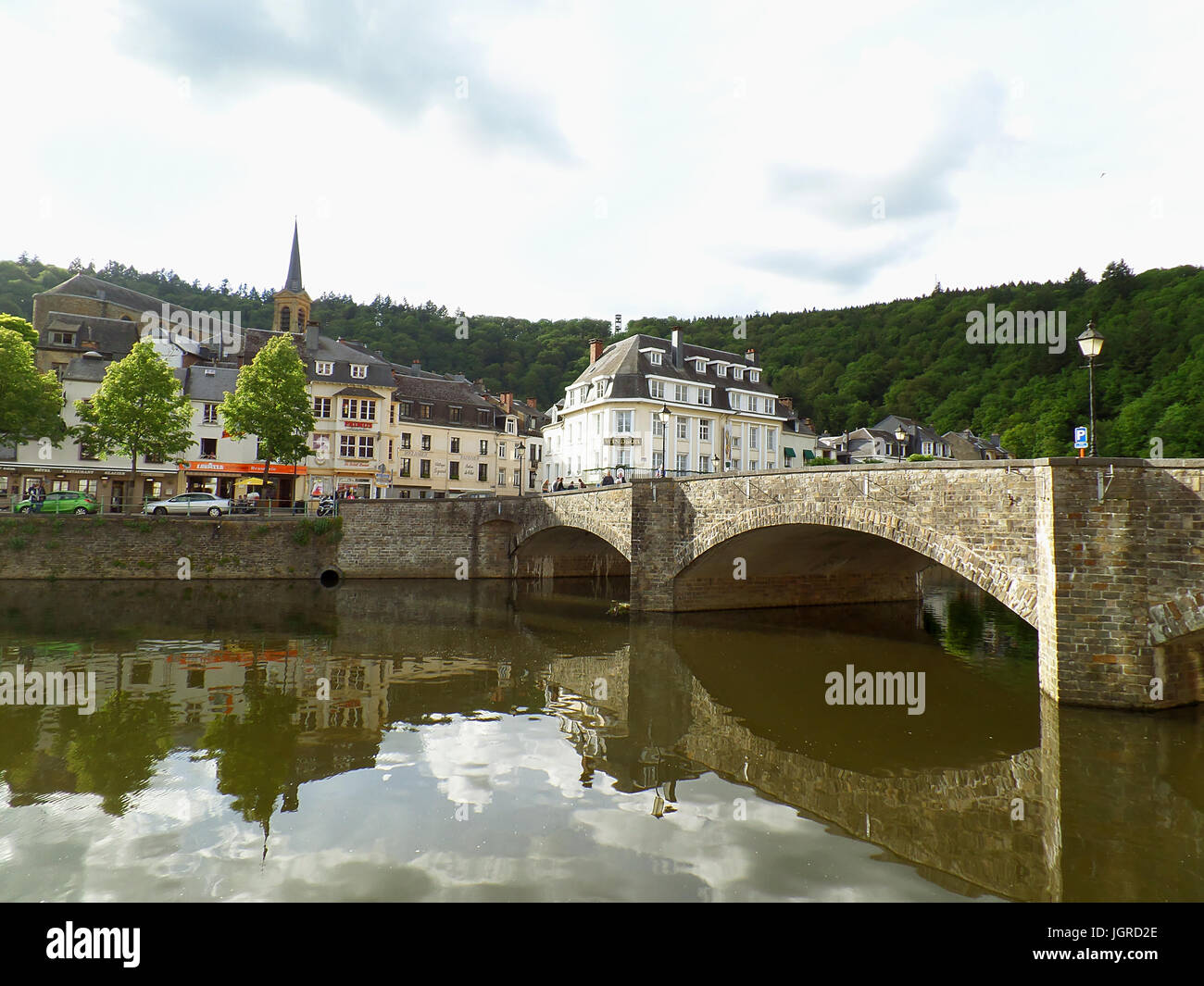 Reflections of the old stone bridge and the vintage buildings on Semois ...