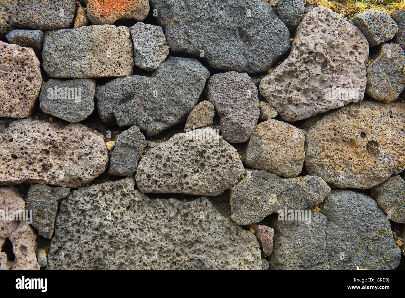 Wall of stone rock boulders Stock Photo - Alamy