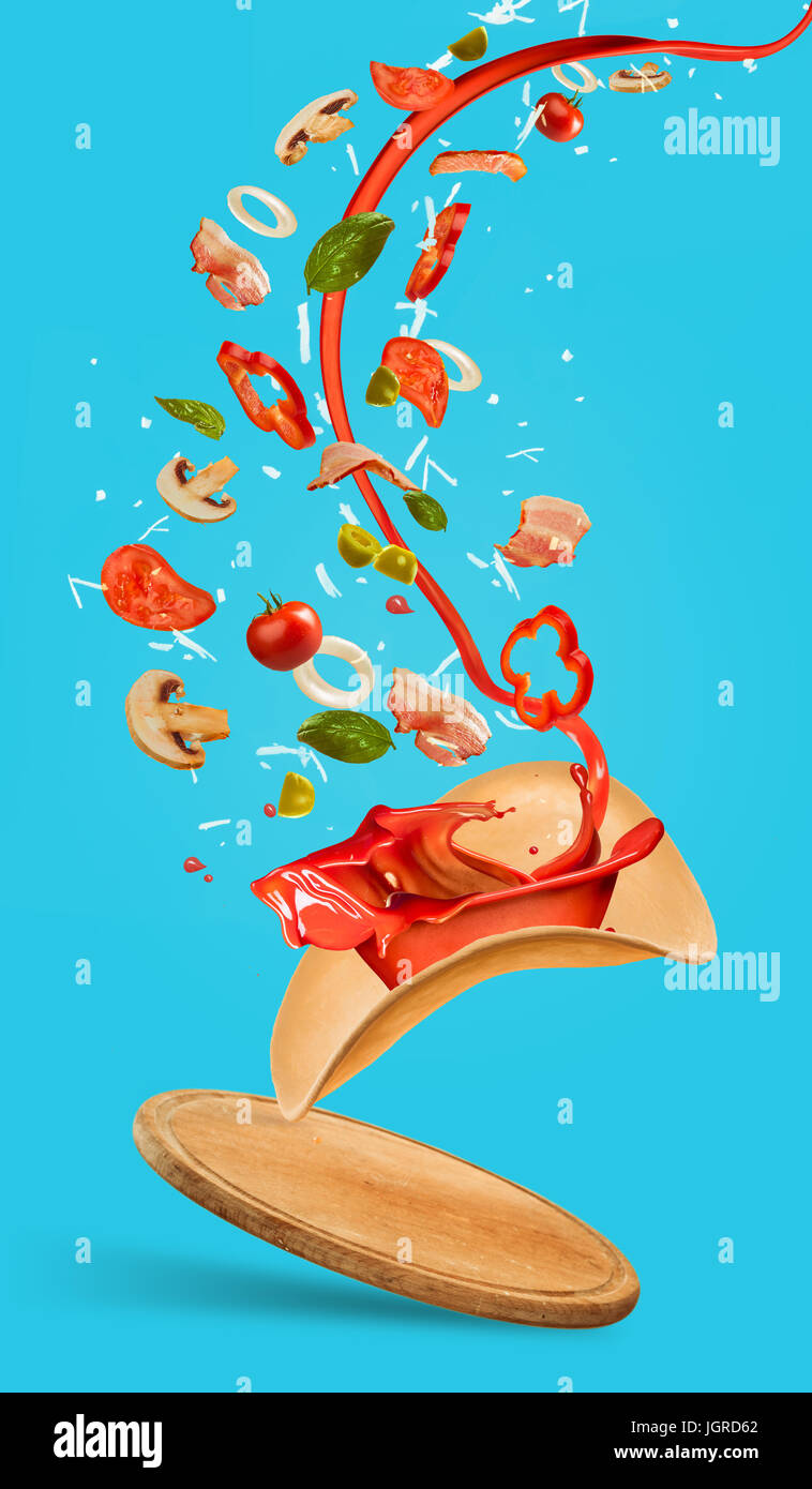 Tasty pizza and falling ingredients on blue background Stock Photo - Alamy