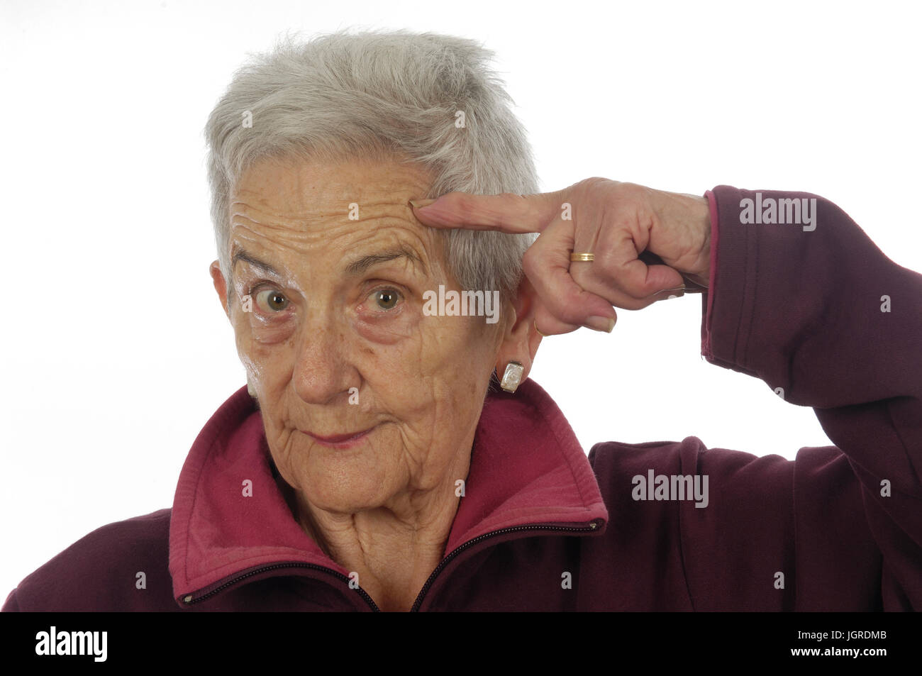senior woman with finger on head Stock Photo - Alamy