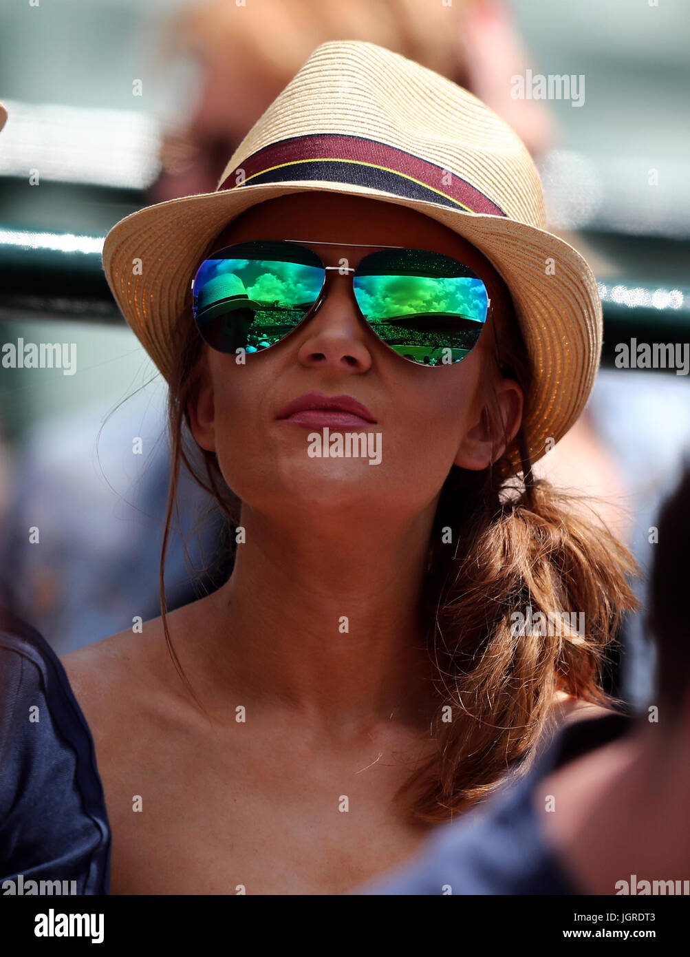 A spectator in the stands of court one on day seven of the Wimbledon ...