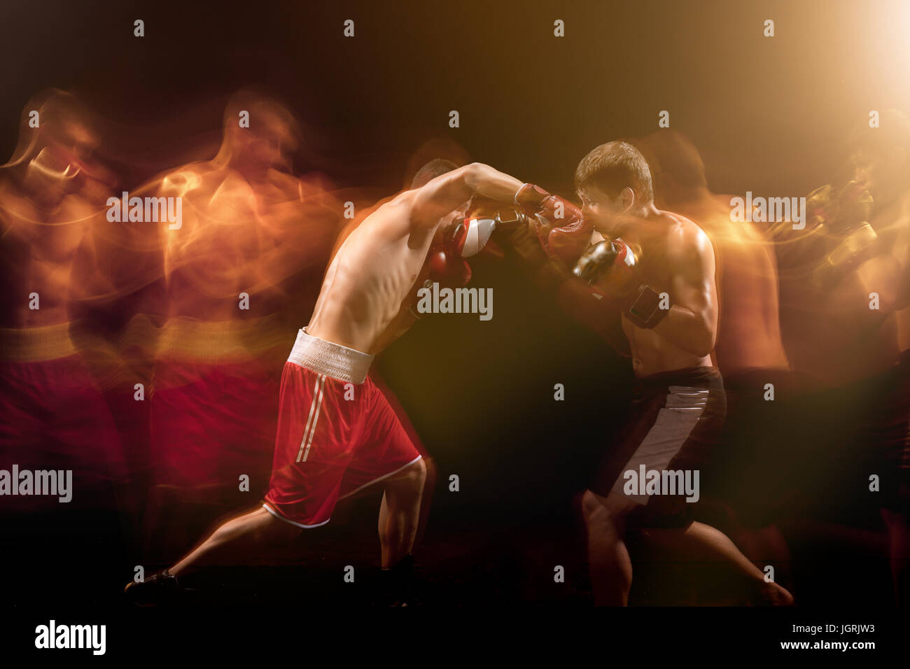 The two male boxers boxing in a dark studio Stock Photo - Alamy