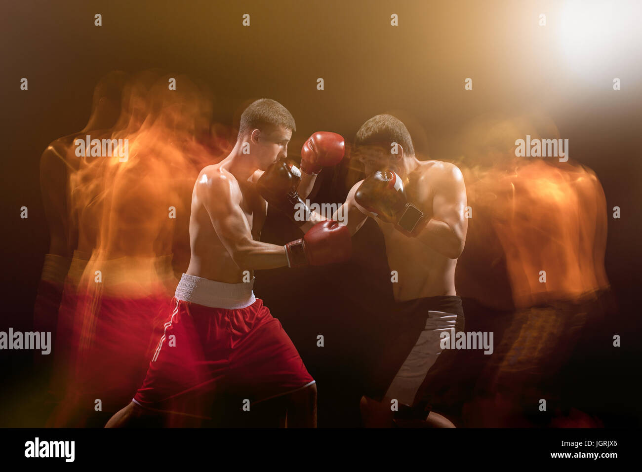 The two male boxers boxing in a dark studio Stock Photo - Alamy
