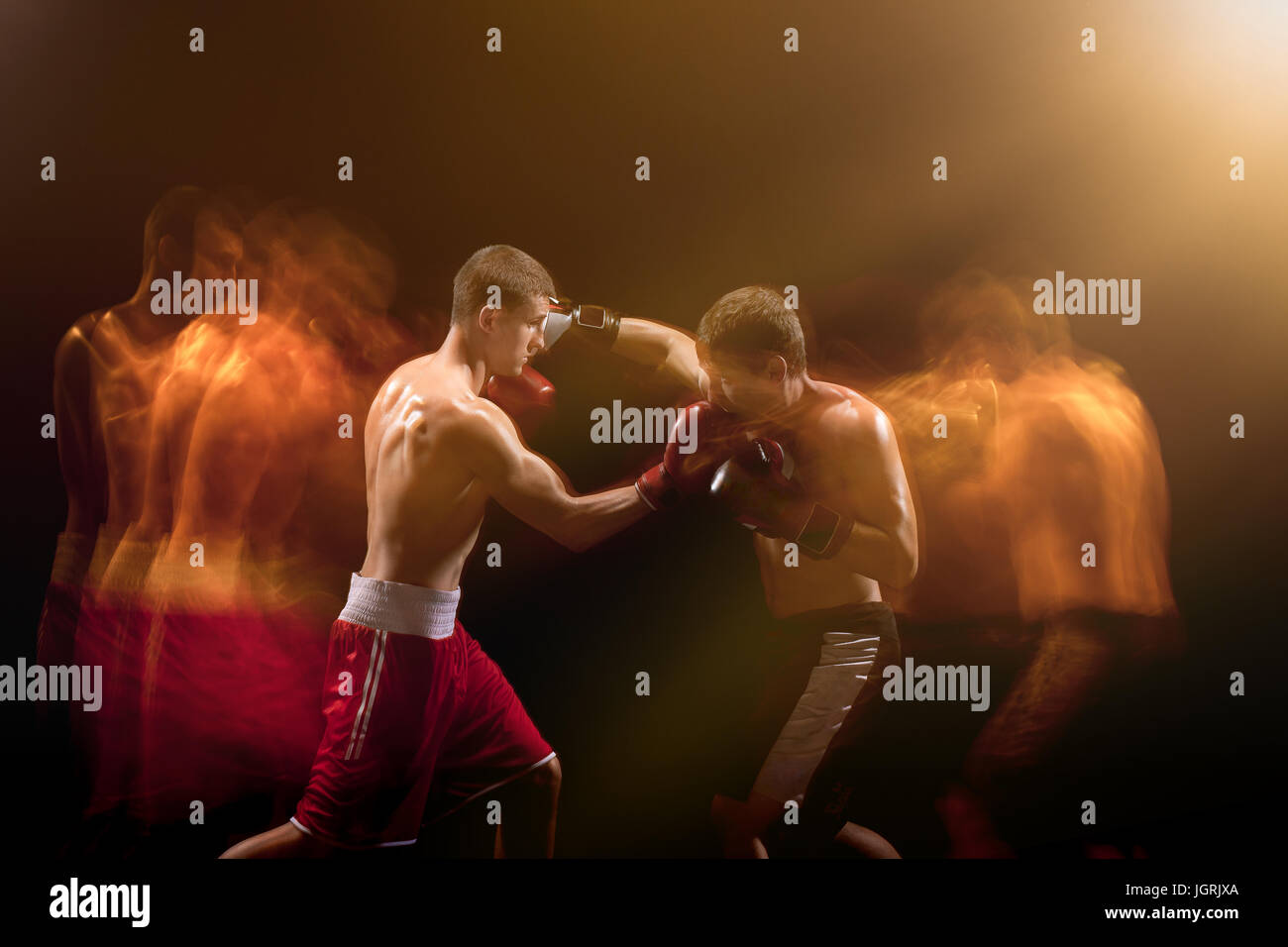 The two male boxers boxing in a dark studio Stock Photo - Alamy