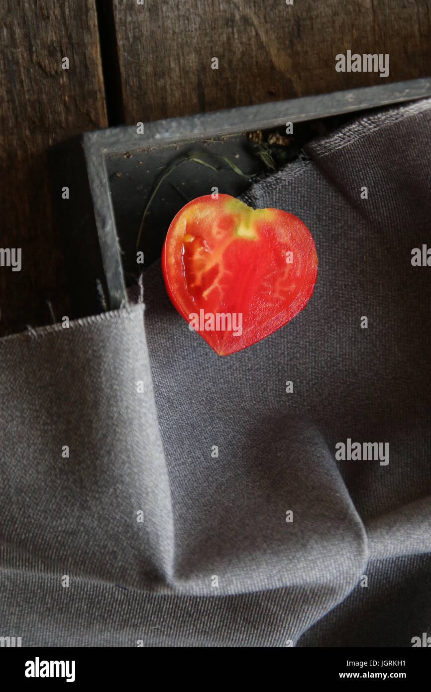Slice of fresh tomato in heart shape Stock Photo - Alamy