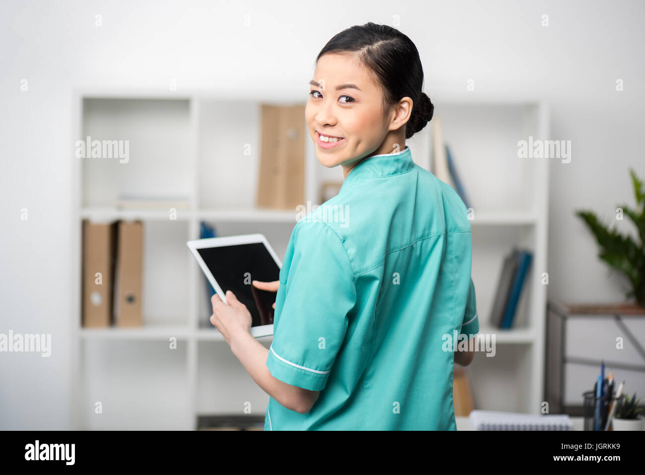 smiling asian internist using digital tablet in professional clinic Stock Photo - Alamy