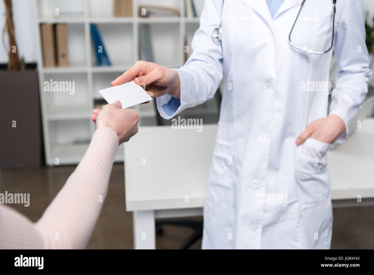Cropped shot of doctor giving blank business card to patient Stock ...