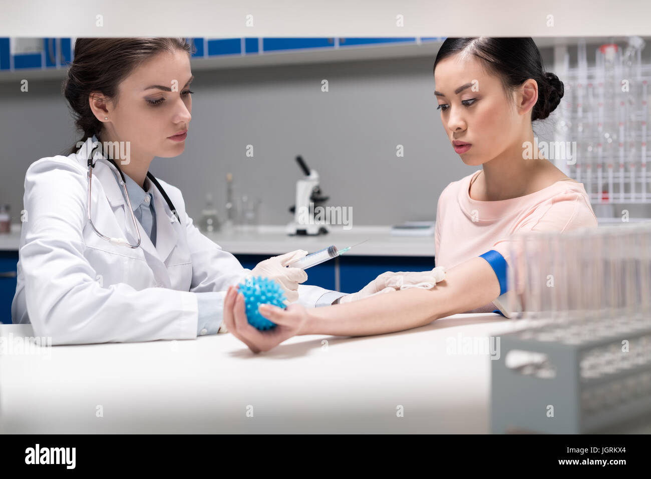 young doctor doing blood test from vein of asian woman Stock Photo - Alamy