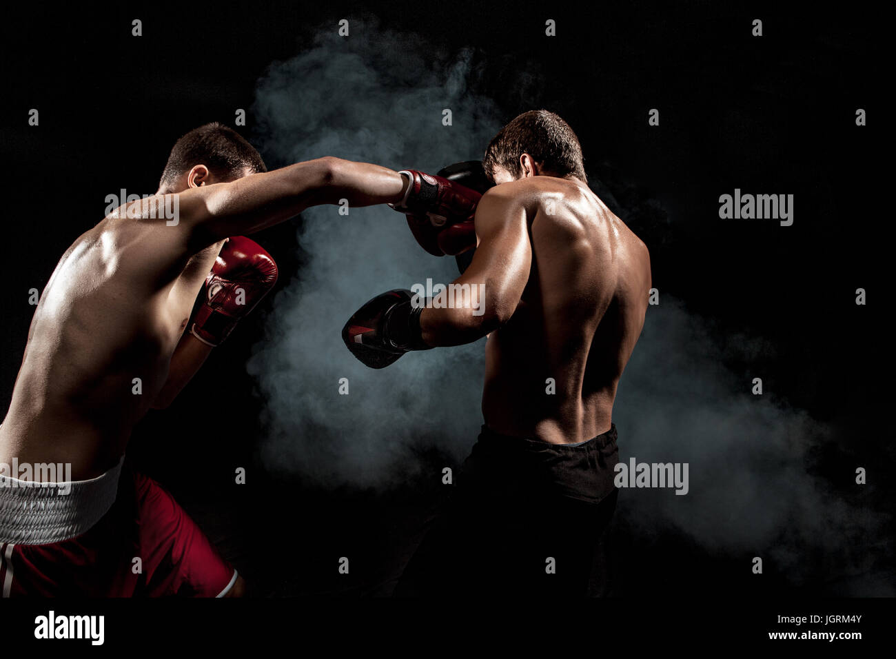Two professional boxer boxing on black smoky background Stock Photo - Alamy