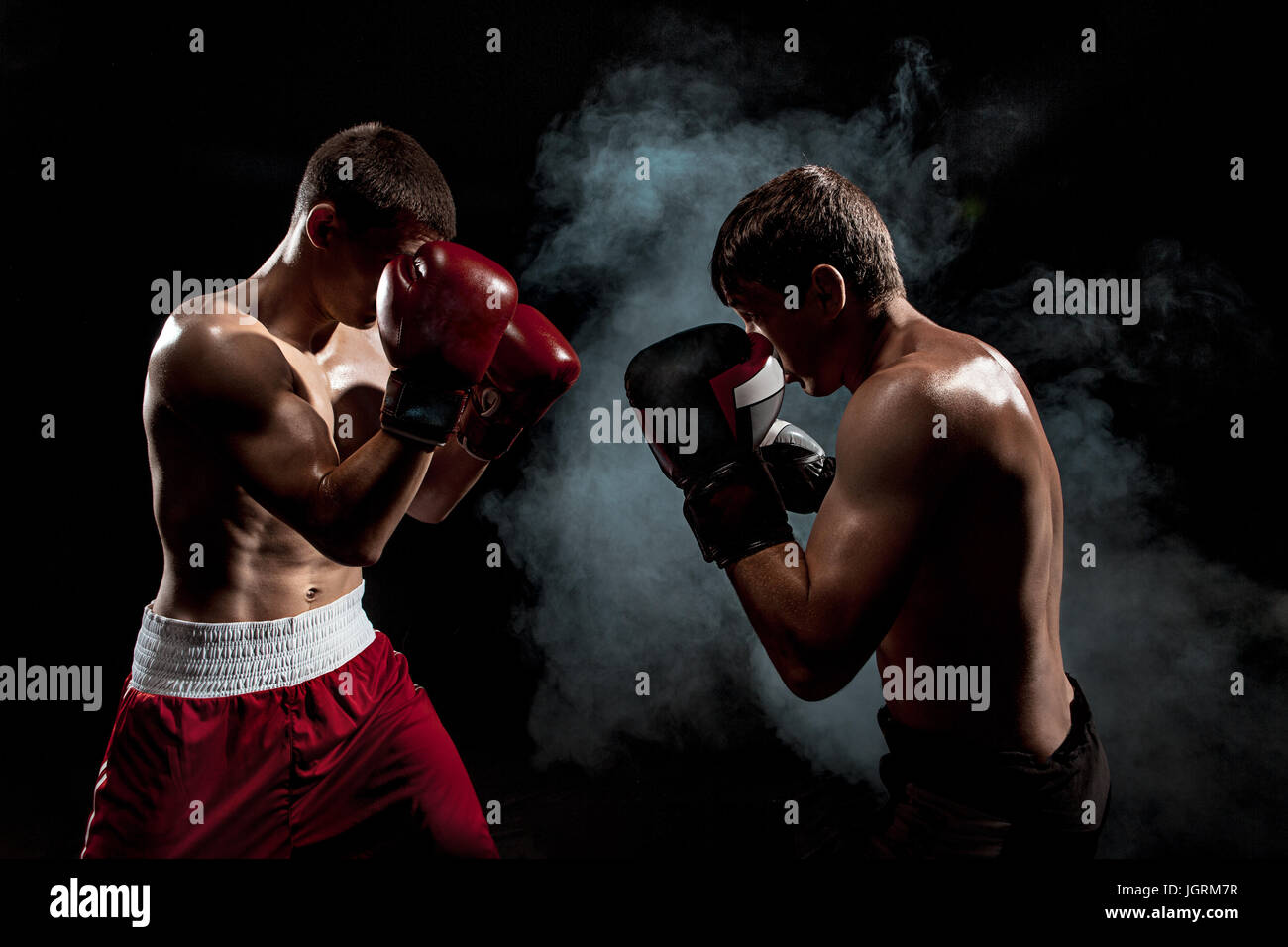Two professional boxer boxing on black smoky background Stock Photo - Alamy