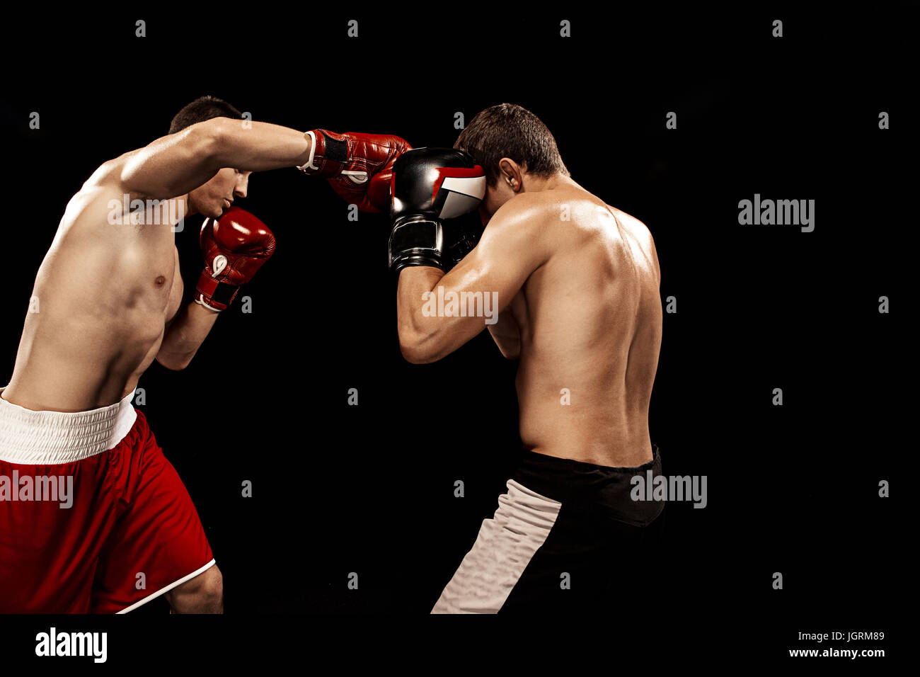 Two professional boxer boxing on black background Stock Photo - Alamy