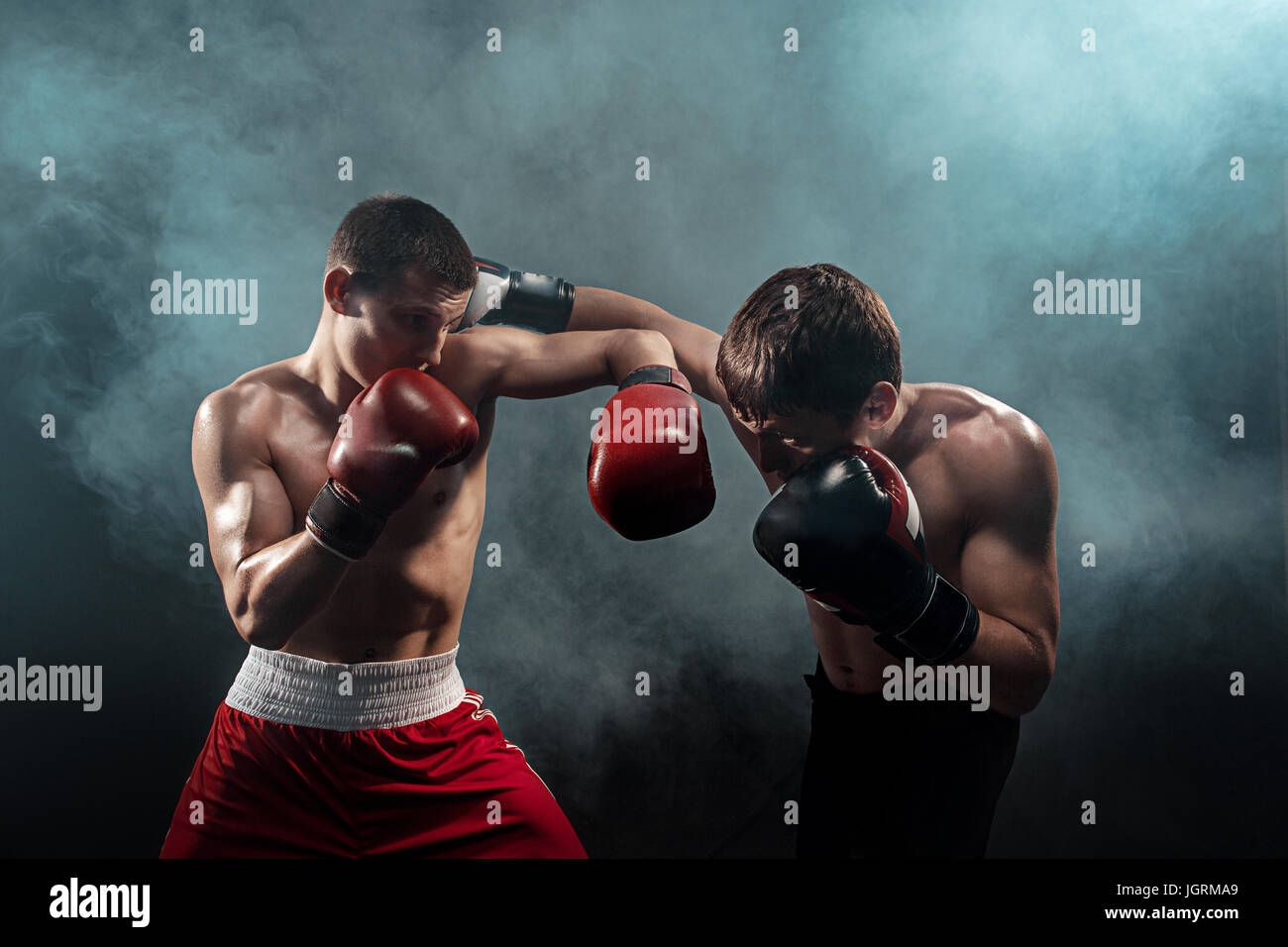 Two professional boxer boxing on black smoky background Stock Photo - Alamy