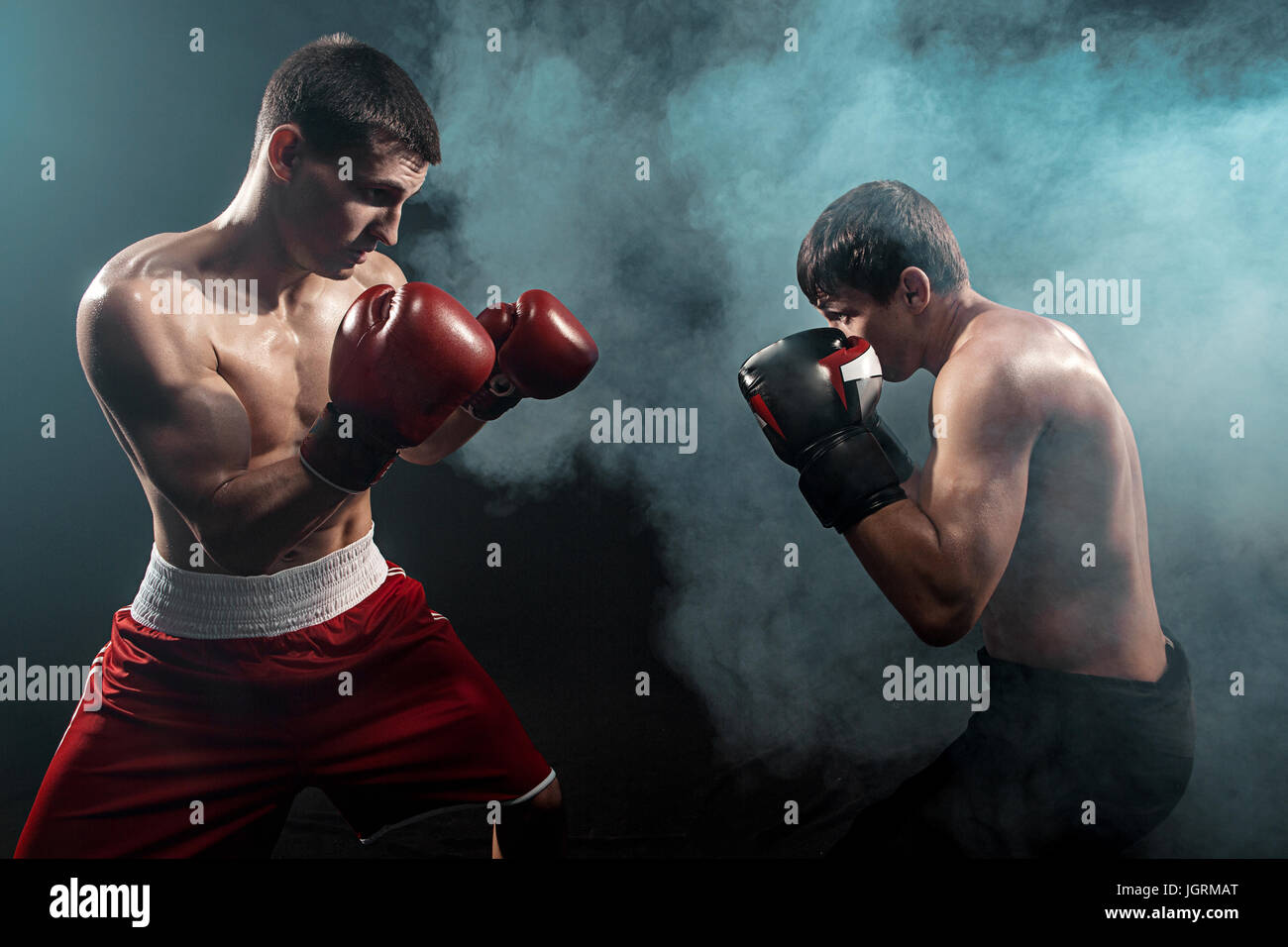 Two professional boxer boxing on black smoky background Stock Photo - Alamy