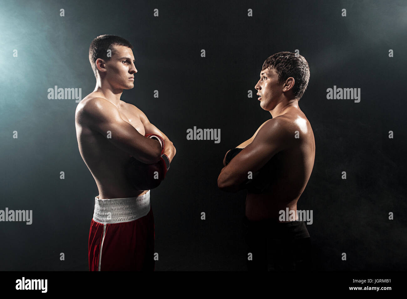Two professional boxer standing on black smoky background Stock Photo ...