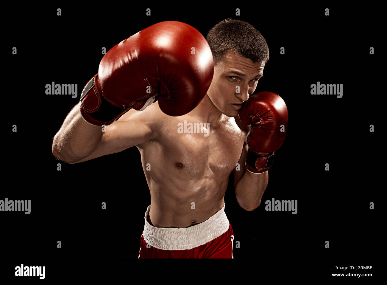 Male boxer boxing with dramatic edgy lighting in a dark studio Stock ...